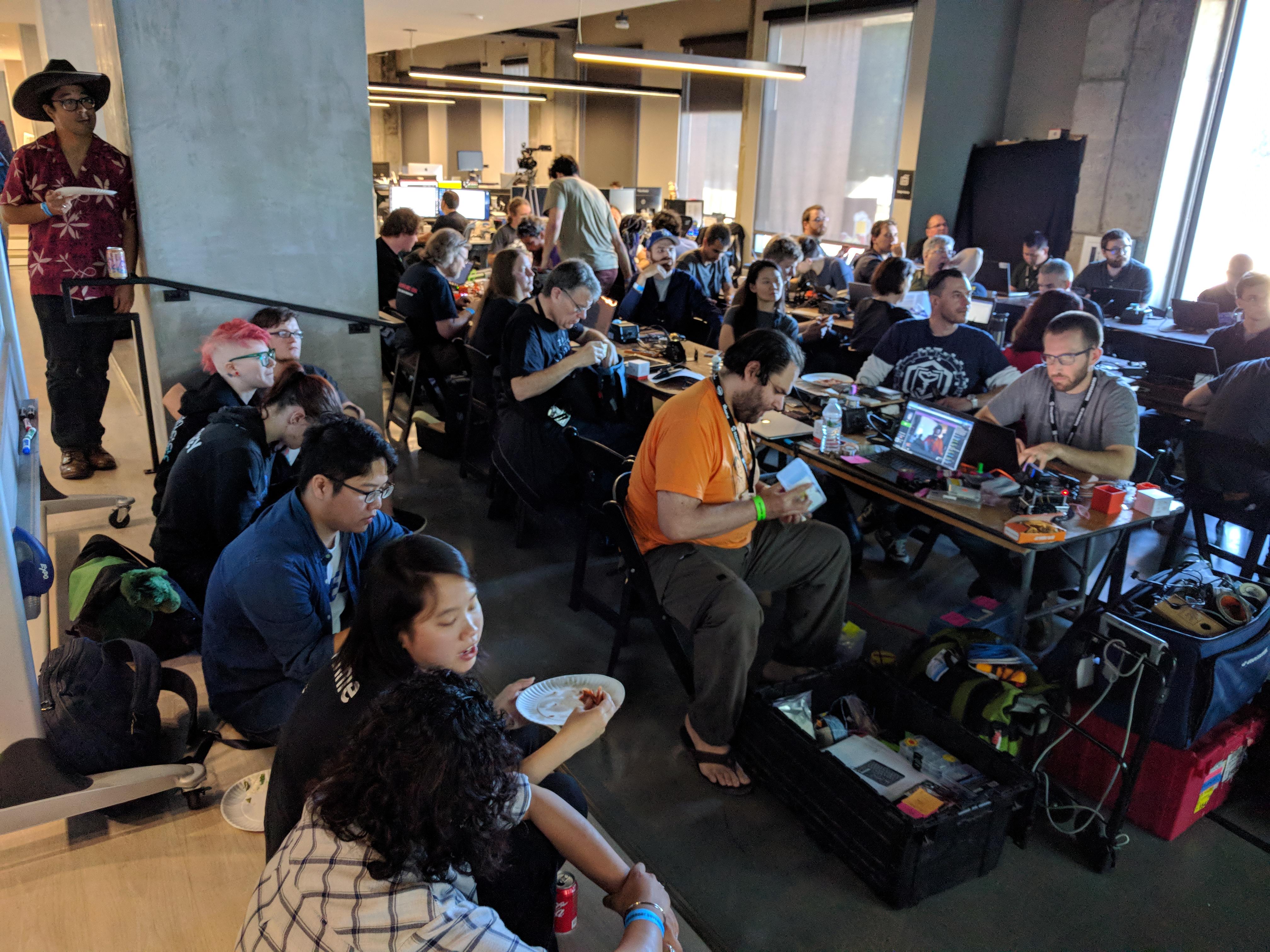 Packed-badge-hacking-area-during-badge-talks | Hackaday